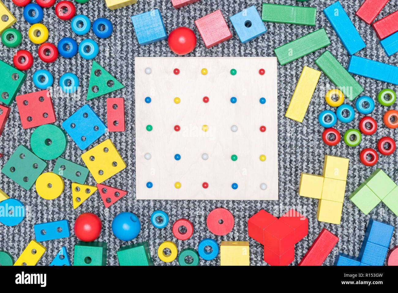 details of a multi-colored children wooden designer on a gray carpet ...