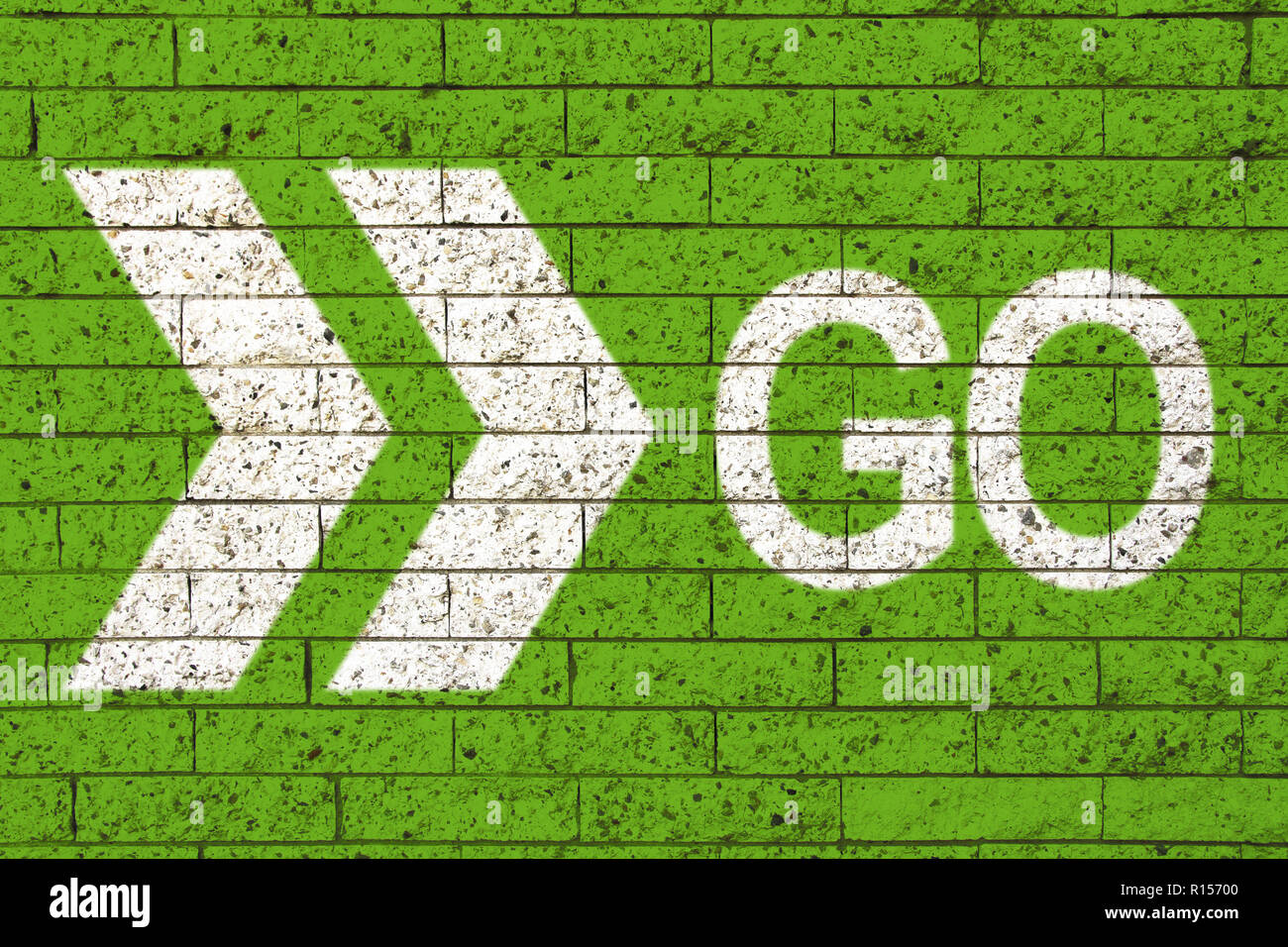 Go white word text and two large direction arrows on green stone brick ...
