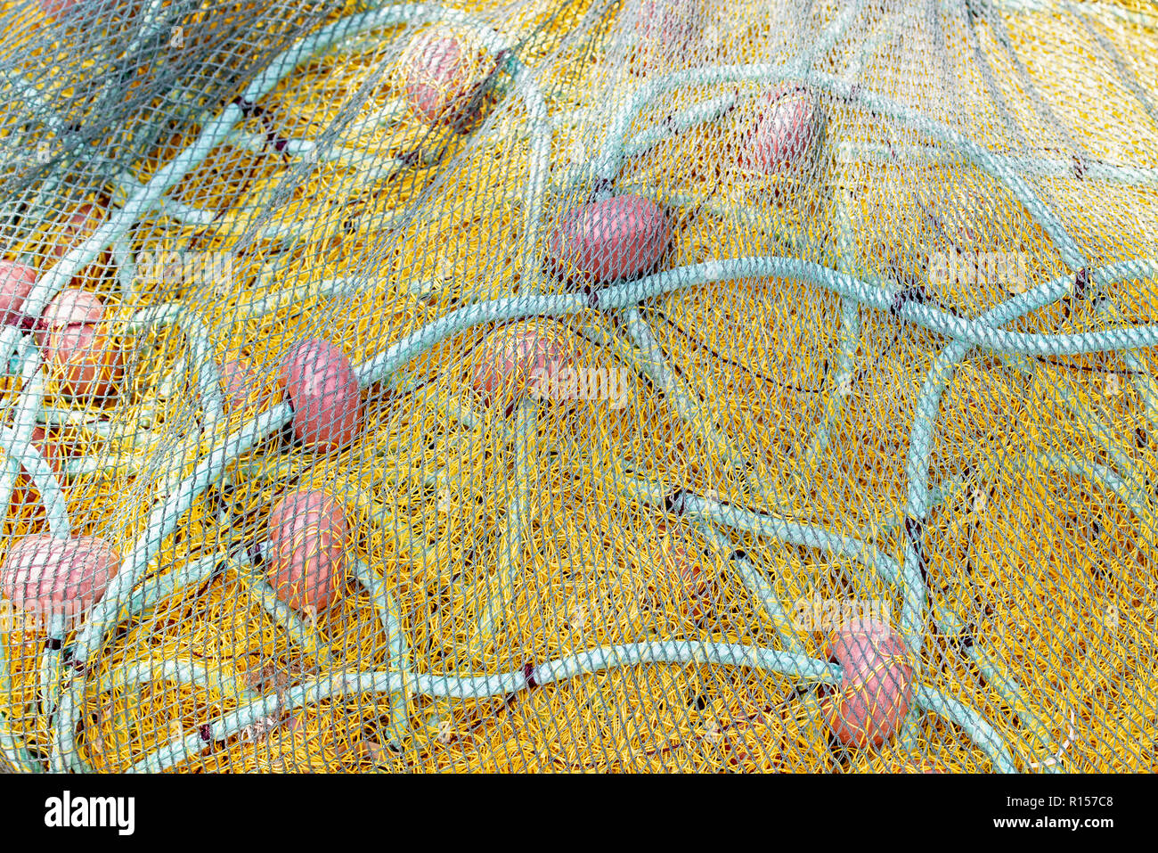 Yellow fishing net drying on the shore. Close up view Stock Photo - Alamy