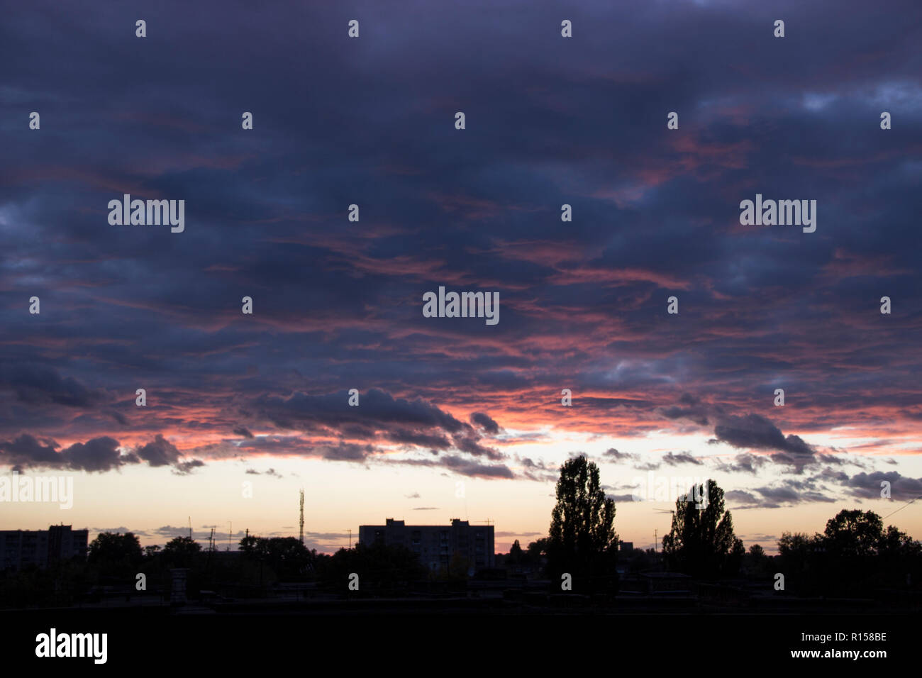 Dark sunset above multistory house. Evening cityscape. City landscape ...
