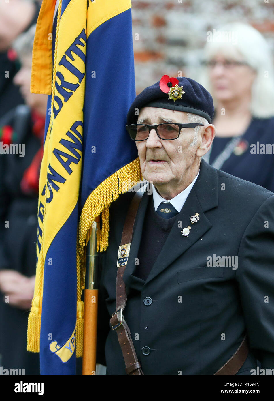 A member of the Royal British Legion holds a standard during the ...