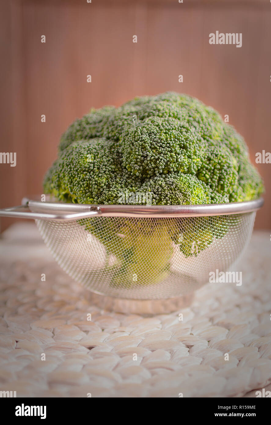 Uncooked broccoli in a colander Stock Photo - Alamy