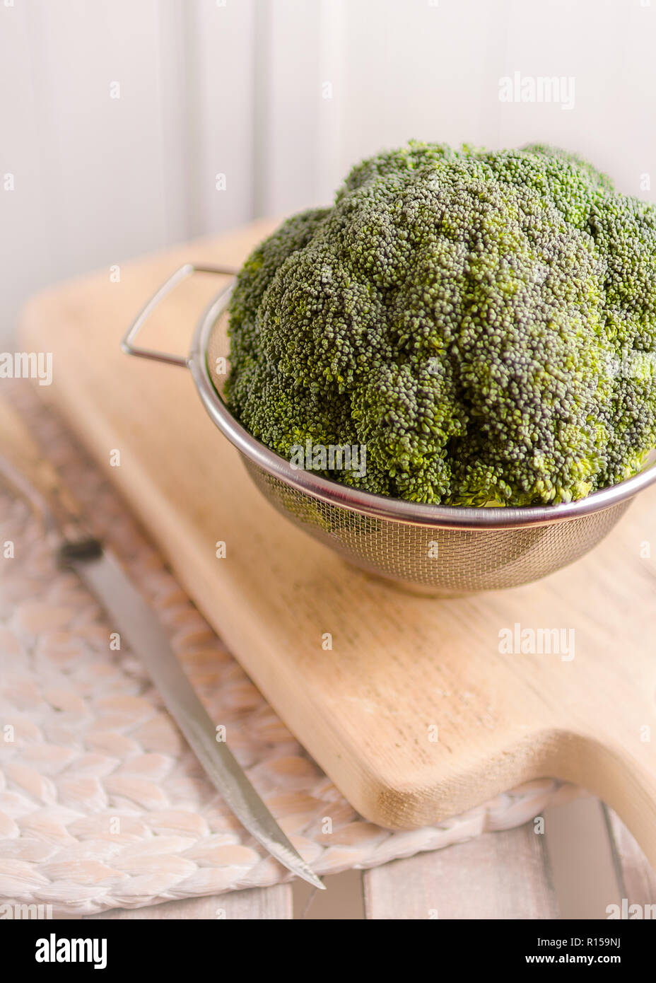 Uncooked broccoli in a colander Stock Photo - Alamy