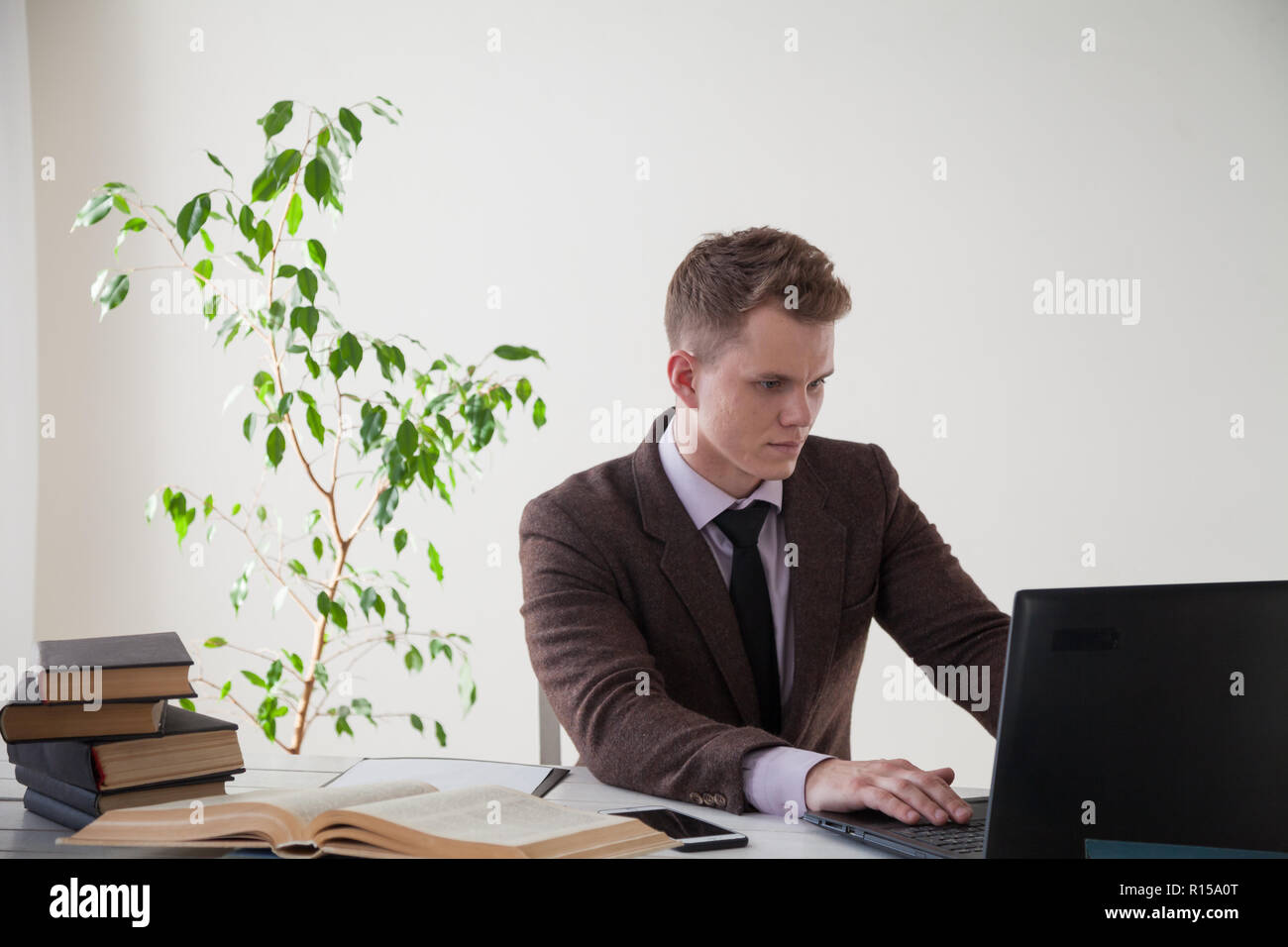 Office man in a business suit at the desk with the computer business ...