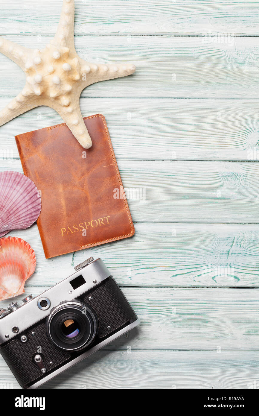 Travel vacation table concept with camera, passport and seashells on ...