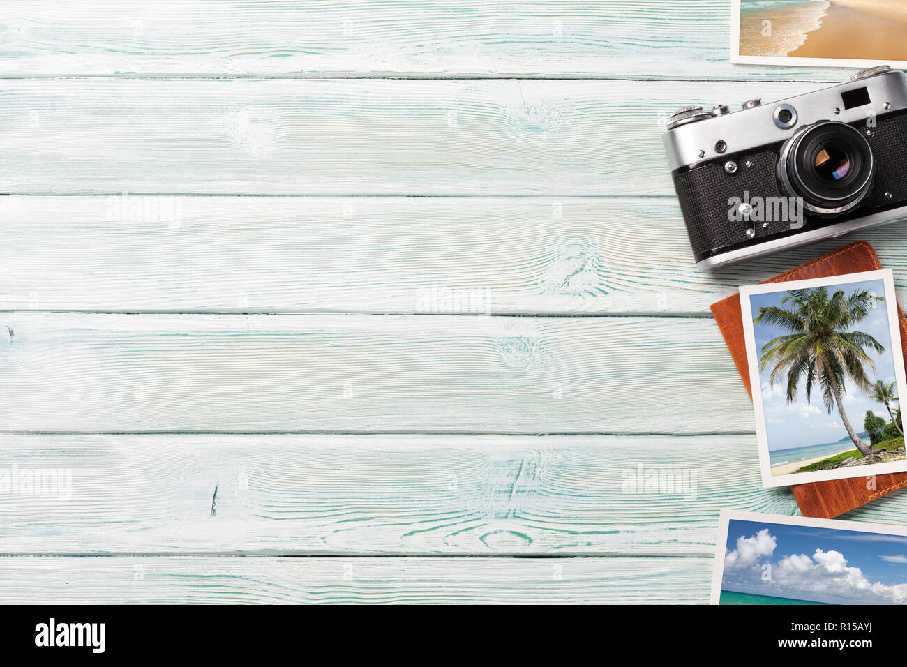 Travel vacation table concept with camera, passport and summer photos ...