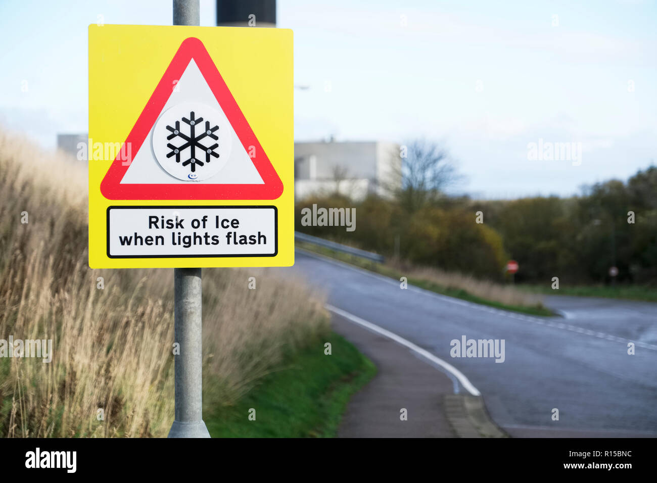 Risk of ice when light flashes winter road safety sign Stock Photo - Alamy