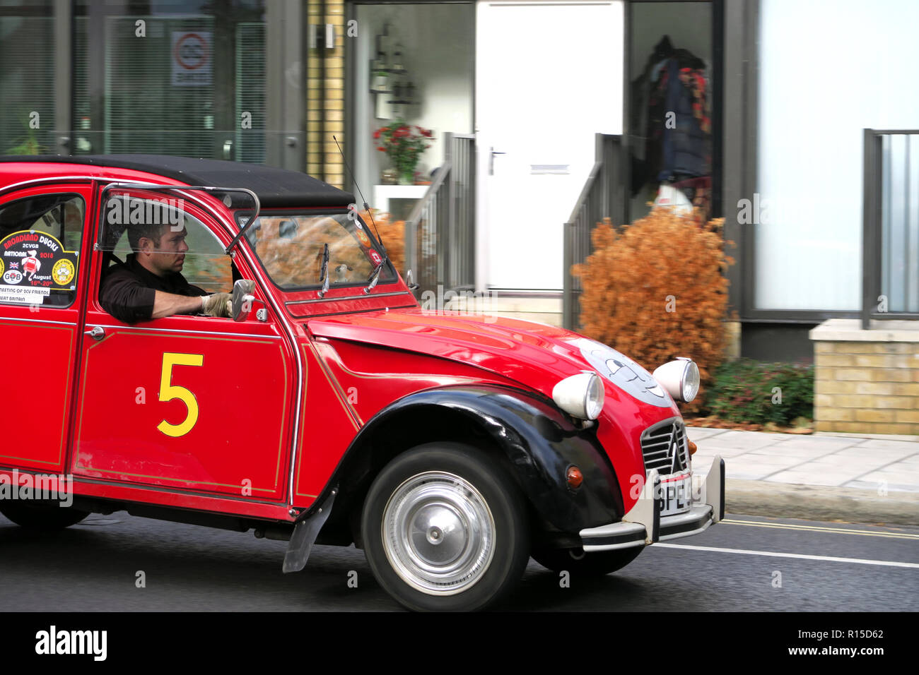 Red Citroen 2CV car driven through steets in Isleworth, Hounslow ...