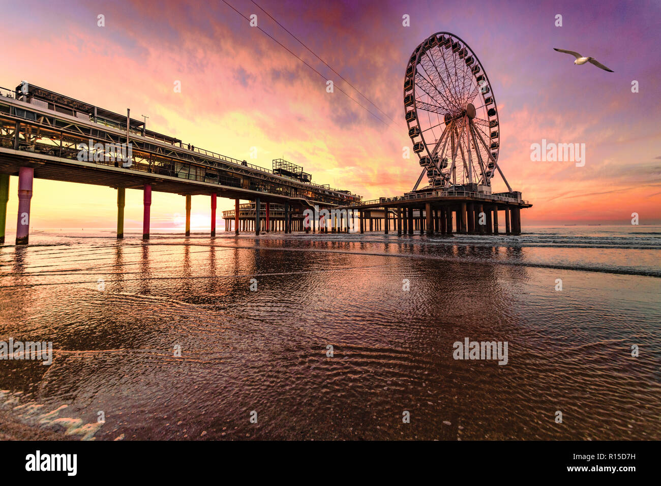 Landscape of a sunset at the beach and the pier of Scheveningen with ...