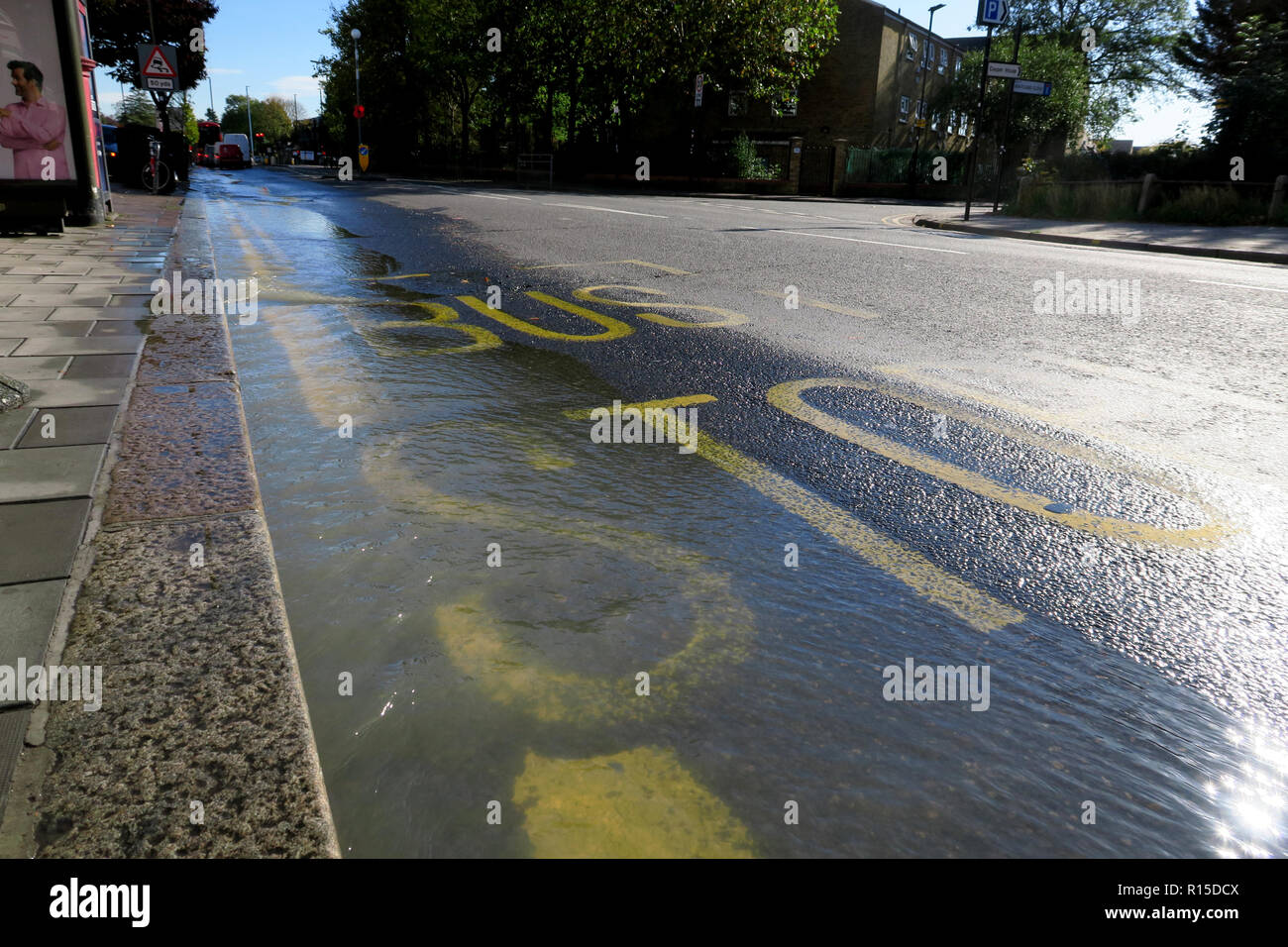 large puddle at bus stop Stock Photo - Alamy