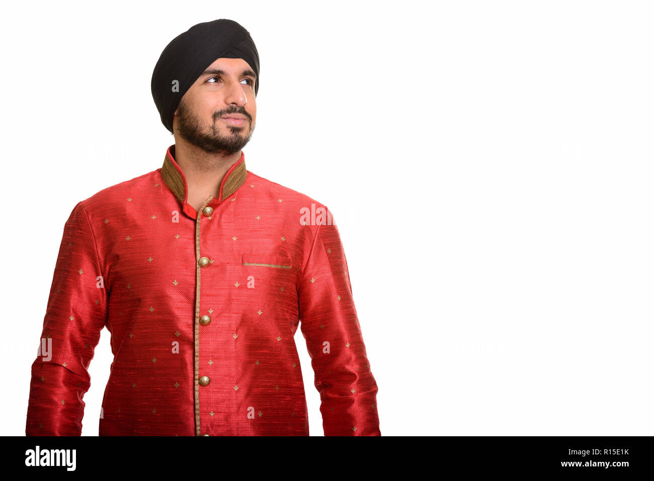 Young handsome Indian Sikh thinking while wearing traditional cl Stock ...