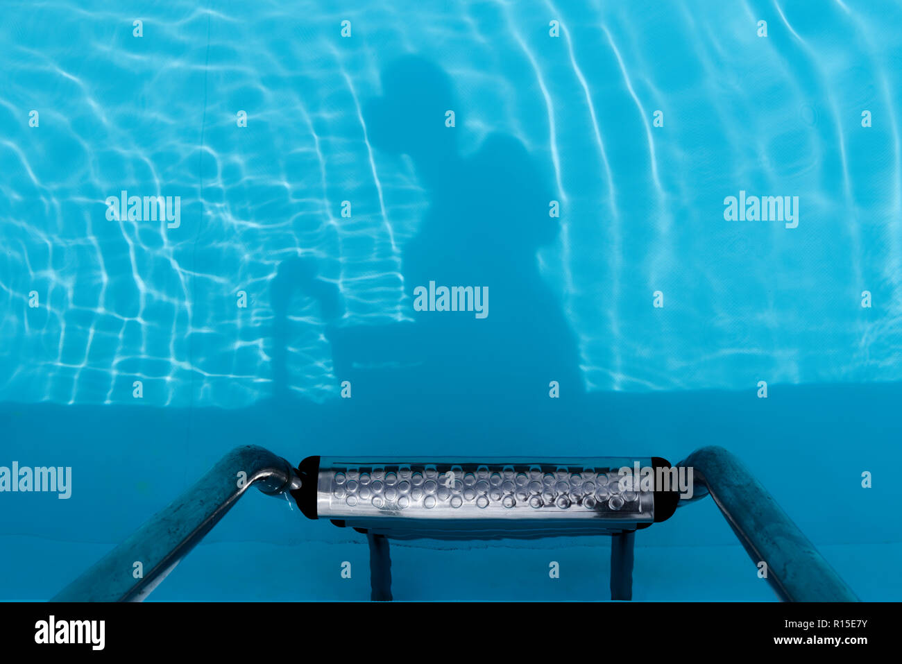 Shadow of human body in a swimming pool at ladder Stock Photo - Alamy