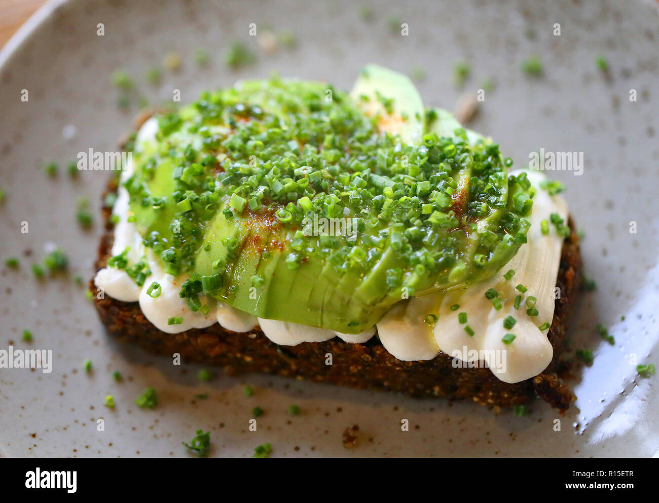 Macro photo of delicious wholesome toast with avocado on a plate in a ...