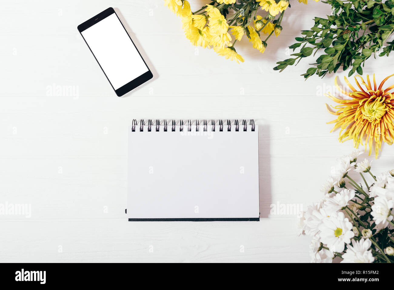 View from above template open empty notepad, mobile phone with blank ...