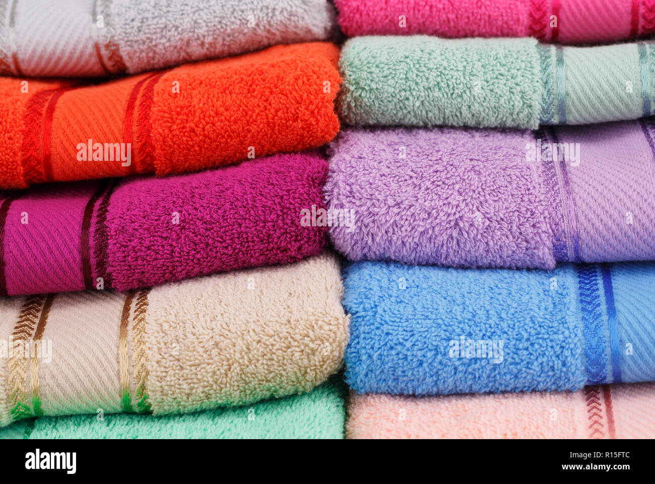 Colorful folded towels stack closeup picture Stock Photo - Alamy