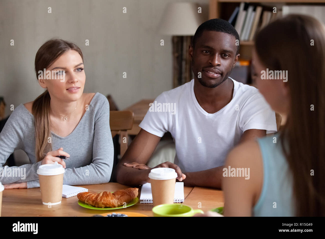 Caucasian girls black african guy talking having pleasant conversation ...