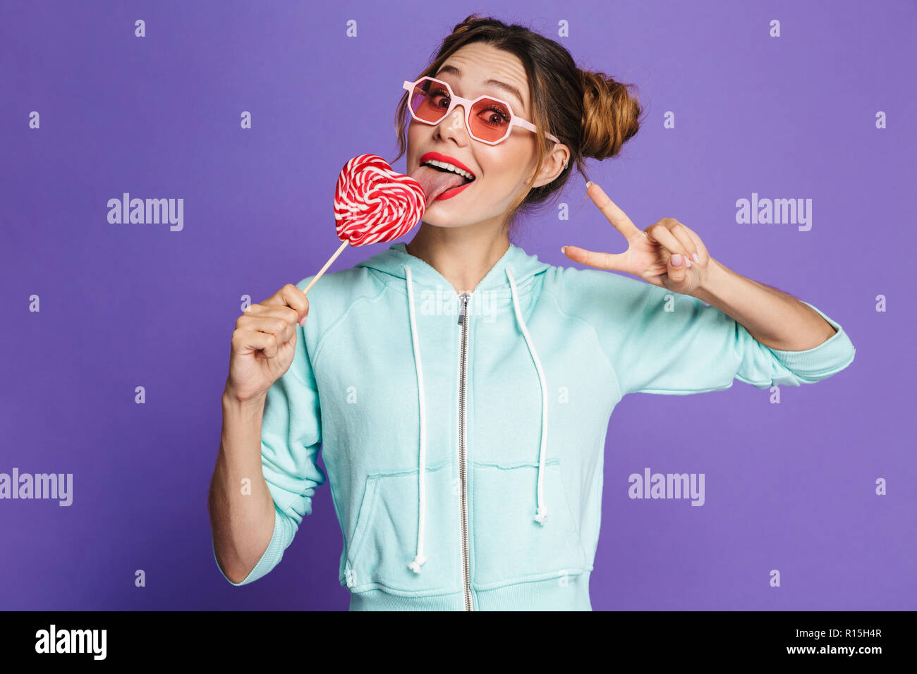 Eating a lollipop smiling hi-res stock photography and images - Alamy