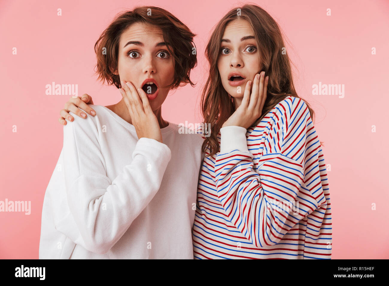 Image of shocked excited women friends isolated over pink wall ...