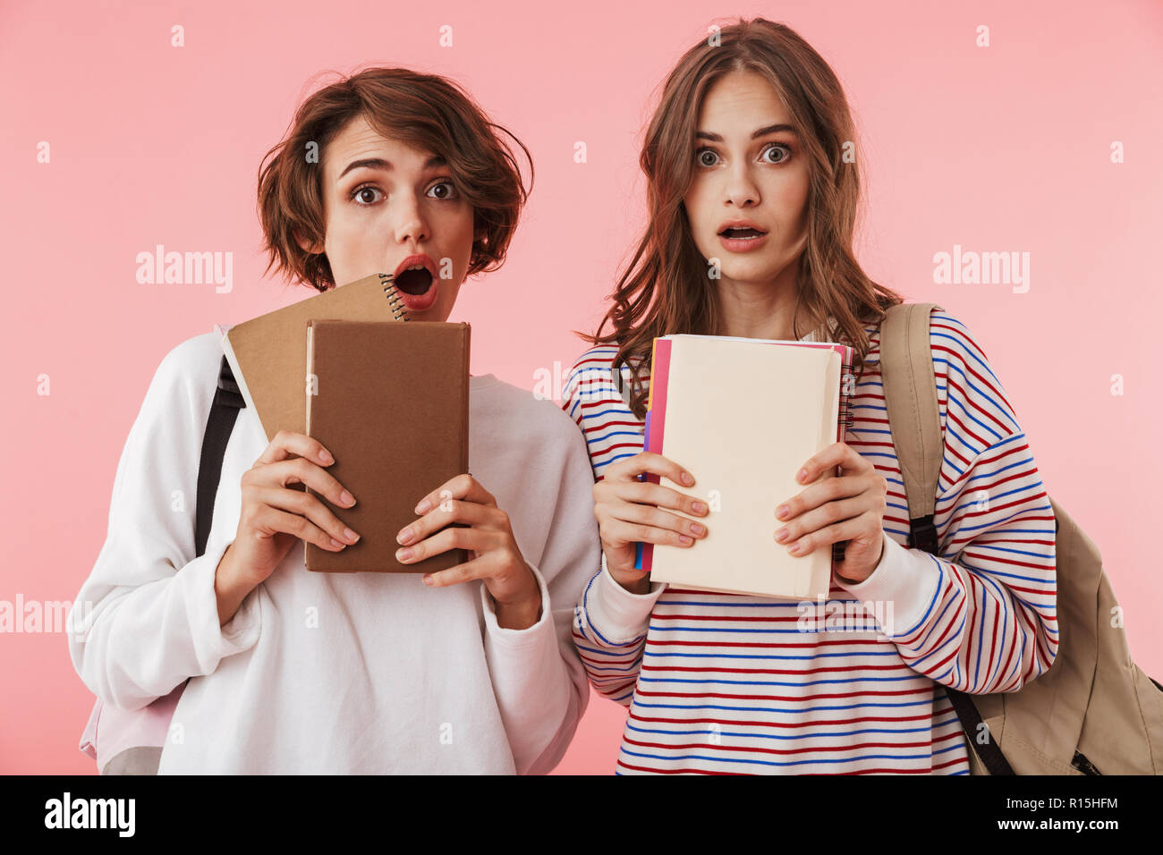 Image of excited shocked women friends isolated over pink wall ...
