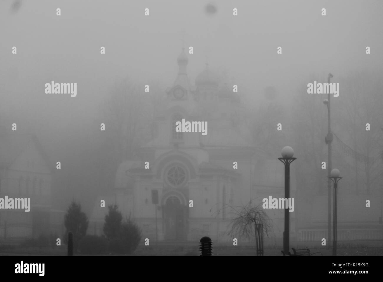 gray deep milky fog covered streets of the city in autumn cold morning ...