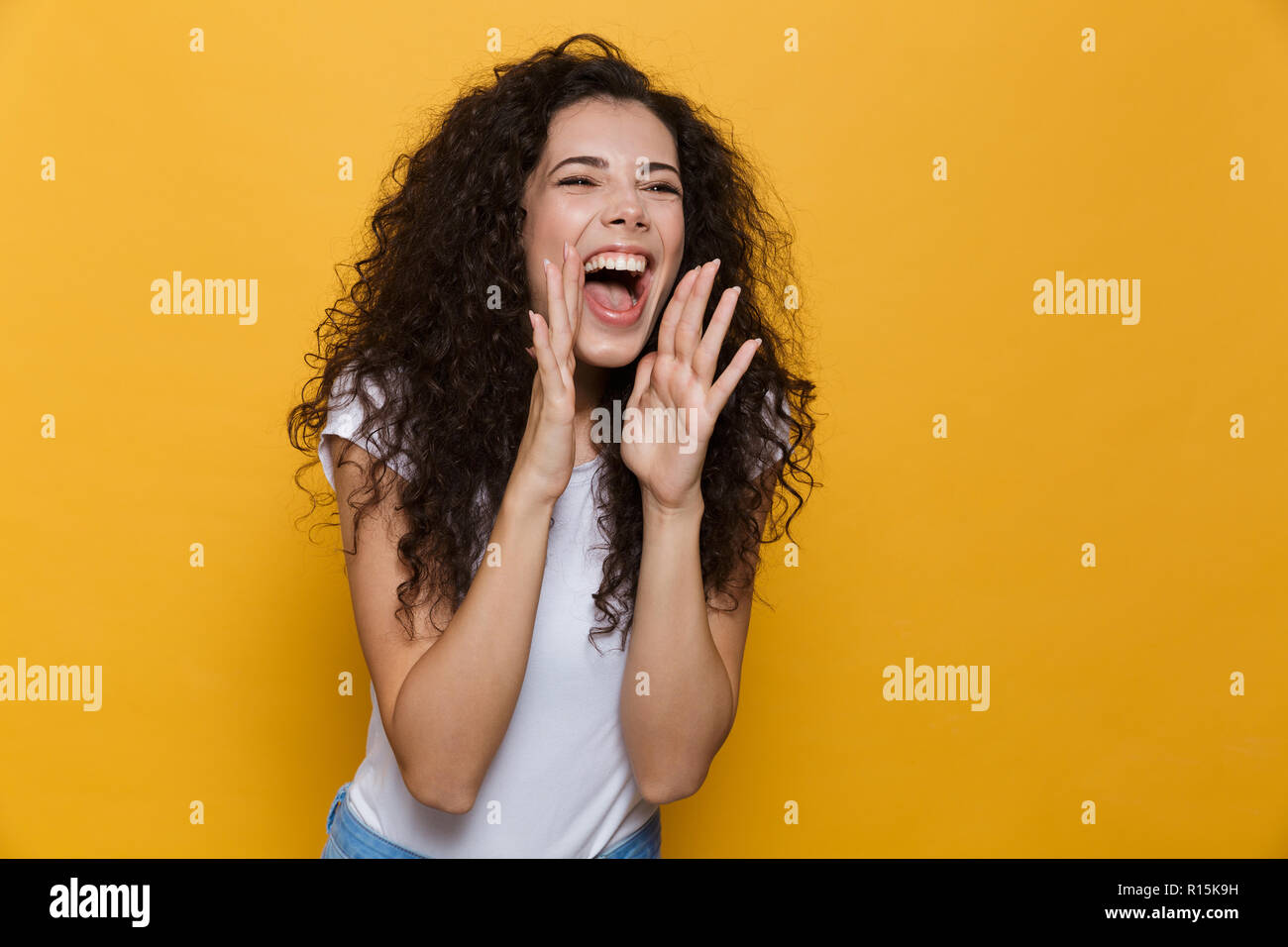 Image of screaming excited young cute woman posing isolated over yellow ...