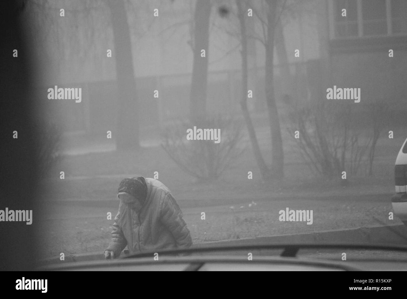 gray deep milky fog covered streets of the city in autumn cold morning ...