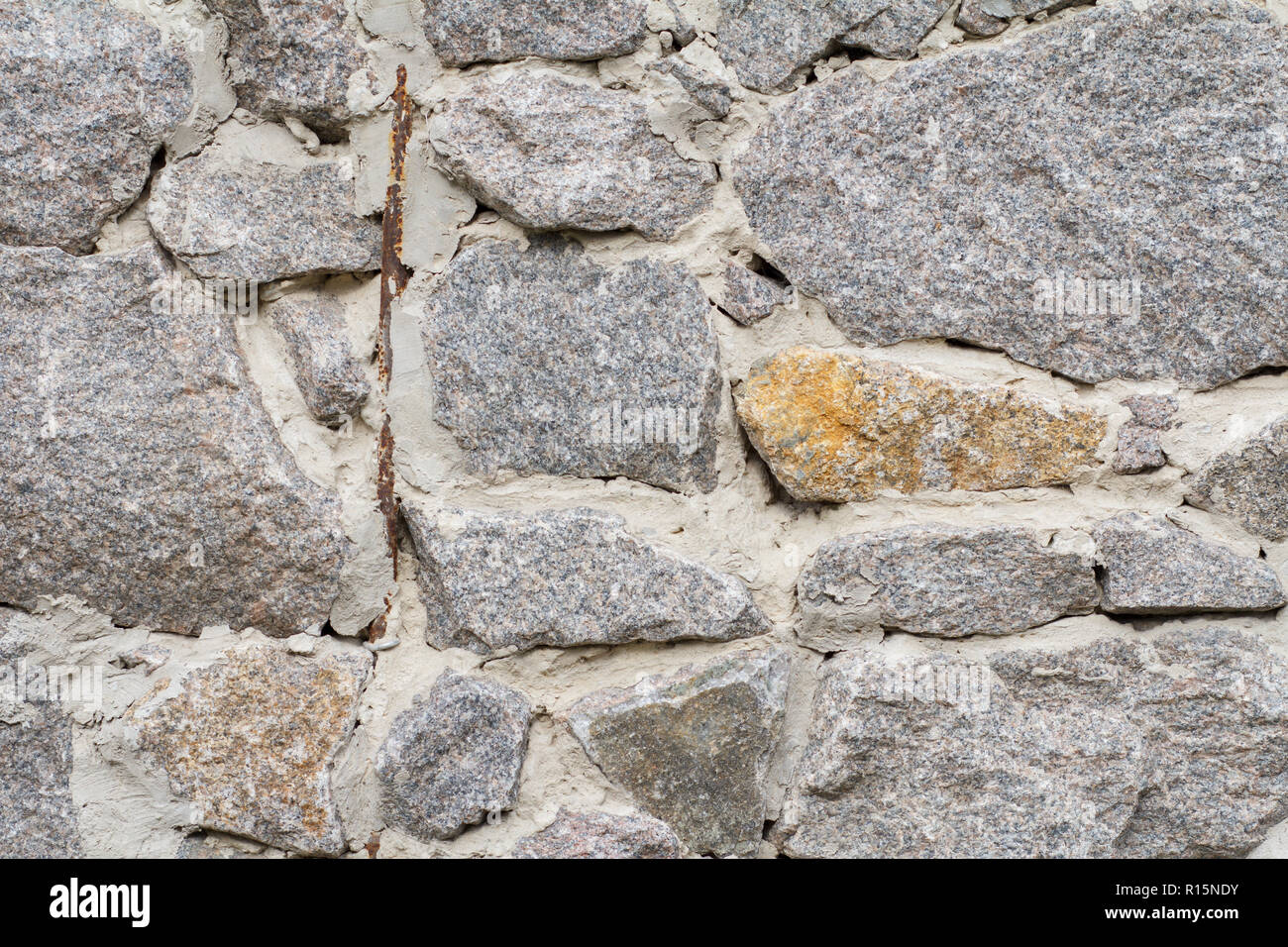 Front view of gray stone wall with cement solution. Natural stone ...