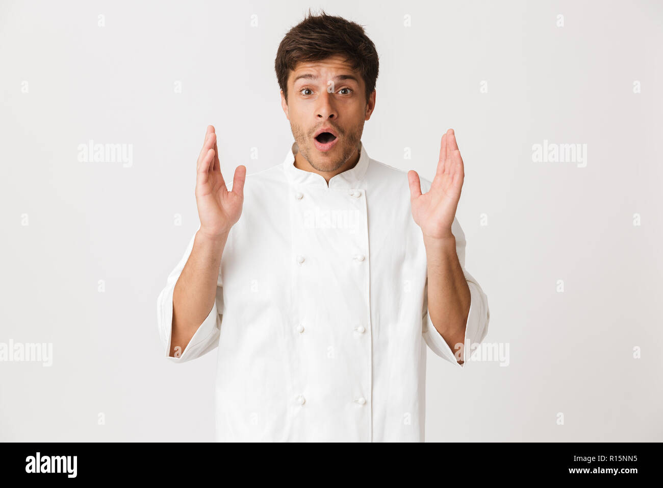 Image of shocked excited young chef man standing isolated over white ...