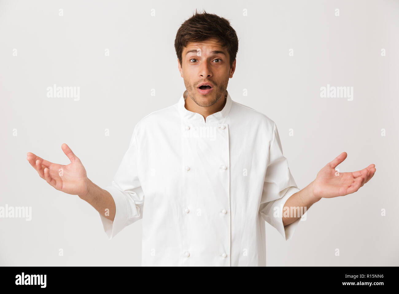 Image of shocked excited young chef man standing isolated over white ...