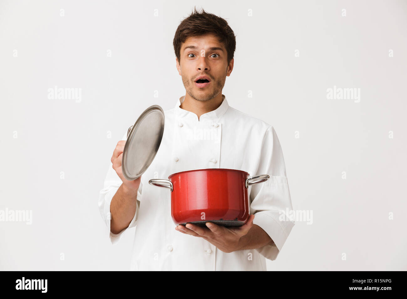 Image of shocked excited young chef man standing isolated over white ...