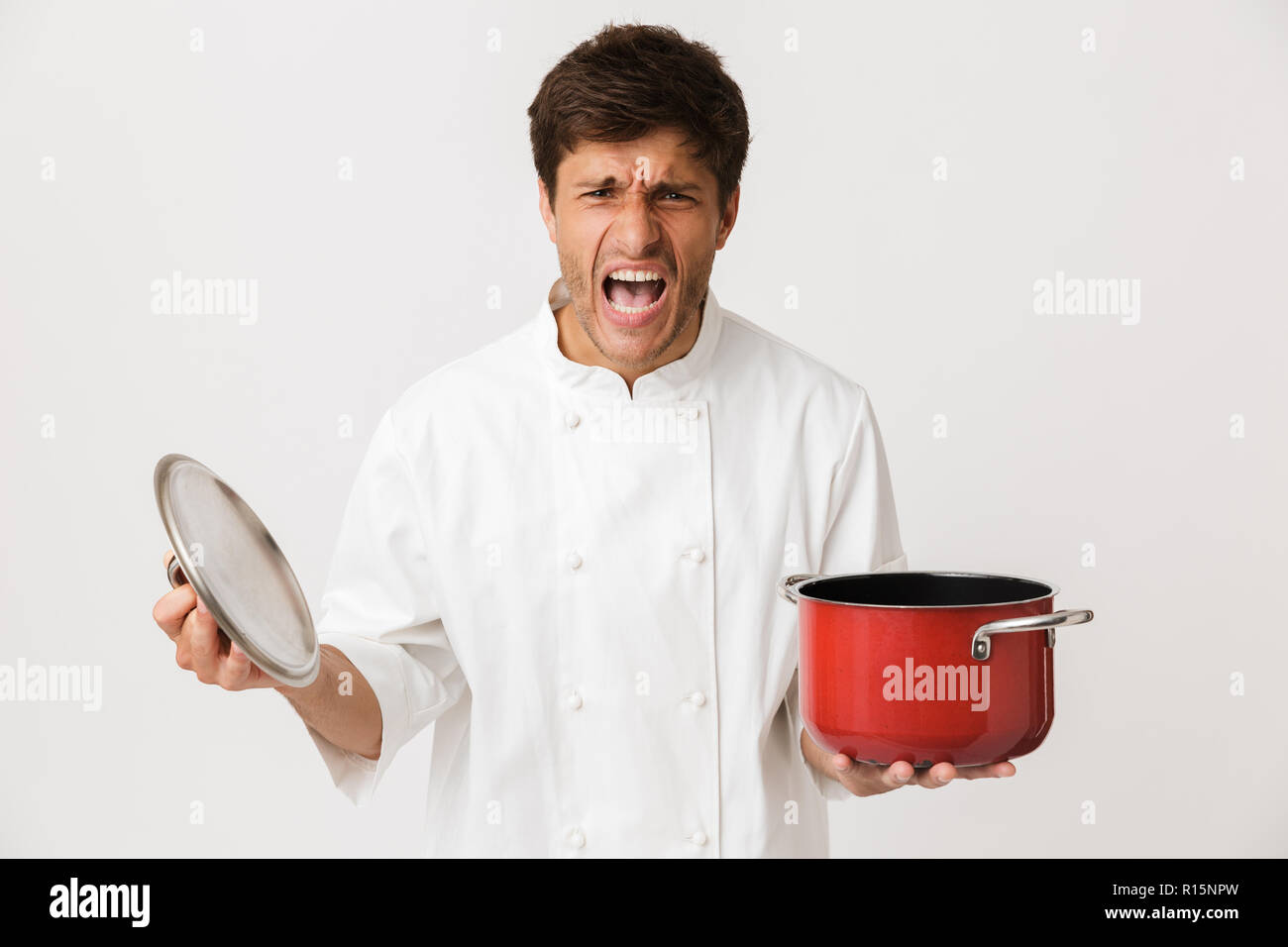 Image of screaming agressive young chef man standing isolated over ...