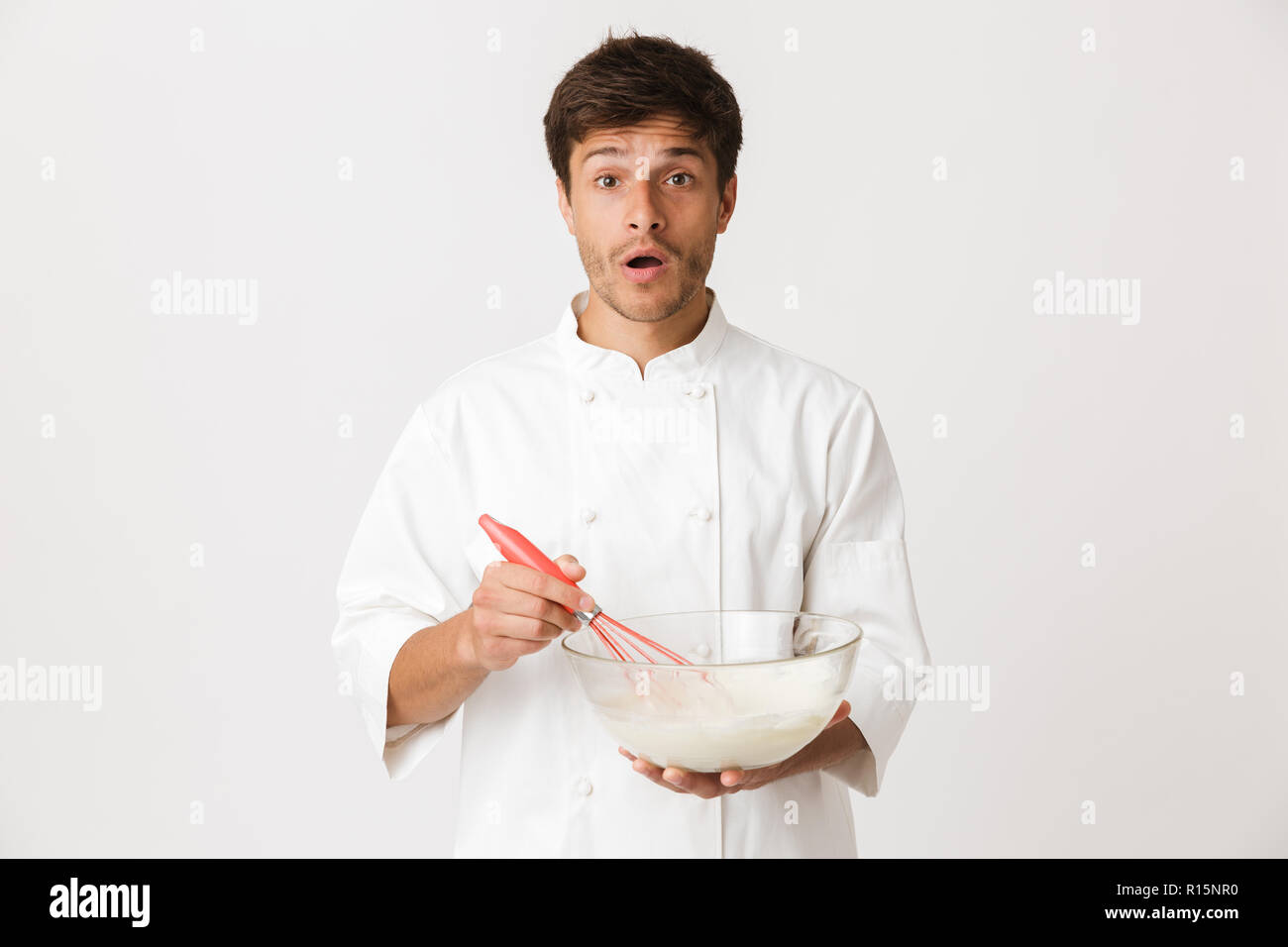 Image of confused shocked young chef isolated over white background ...