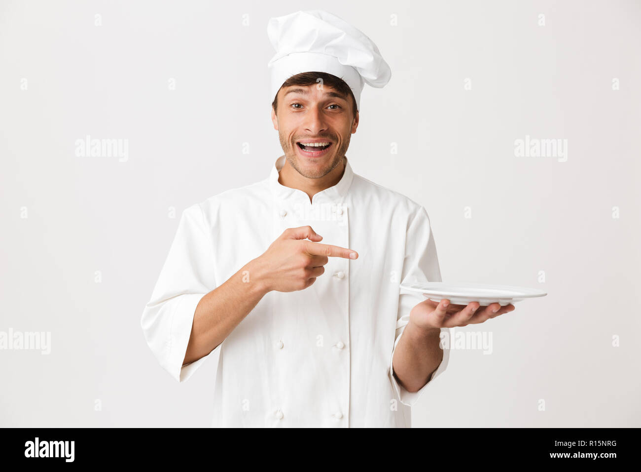 Image of handsome young chef isolated over white background holding ...