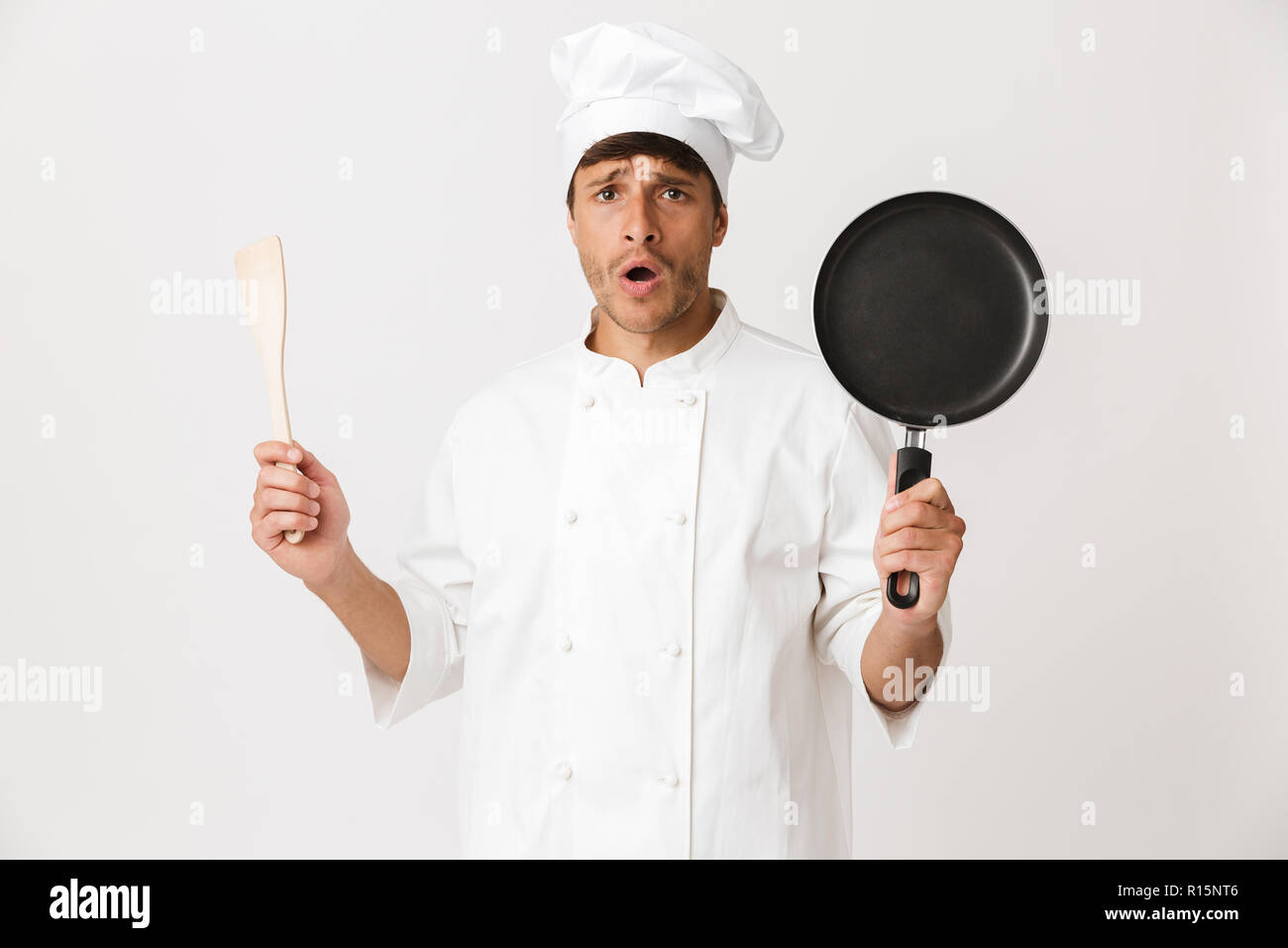 Image of shocked emotional young chef man standing isolated over white ...