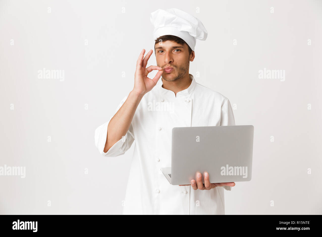 Image of handsome young chef man isolated over white wall background ...
