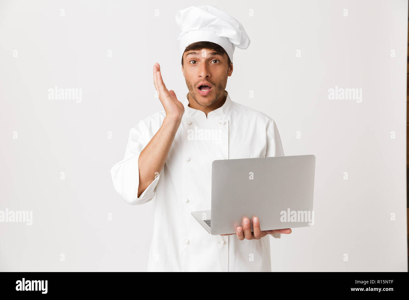 Image of shocked young chef man isolated over white wall background ...