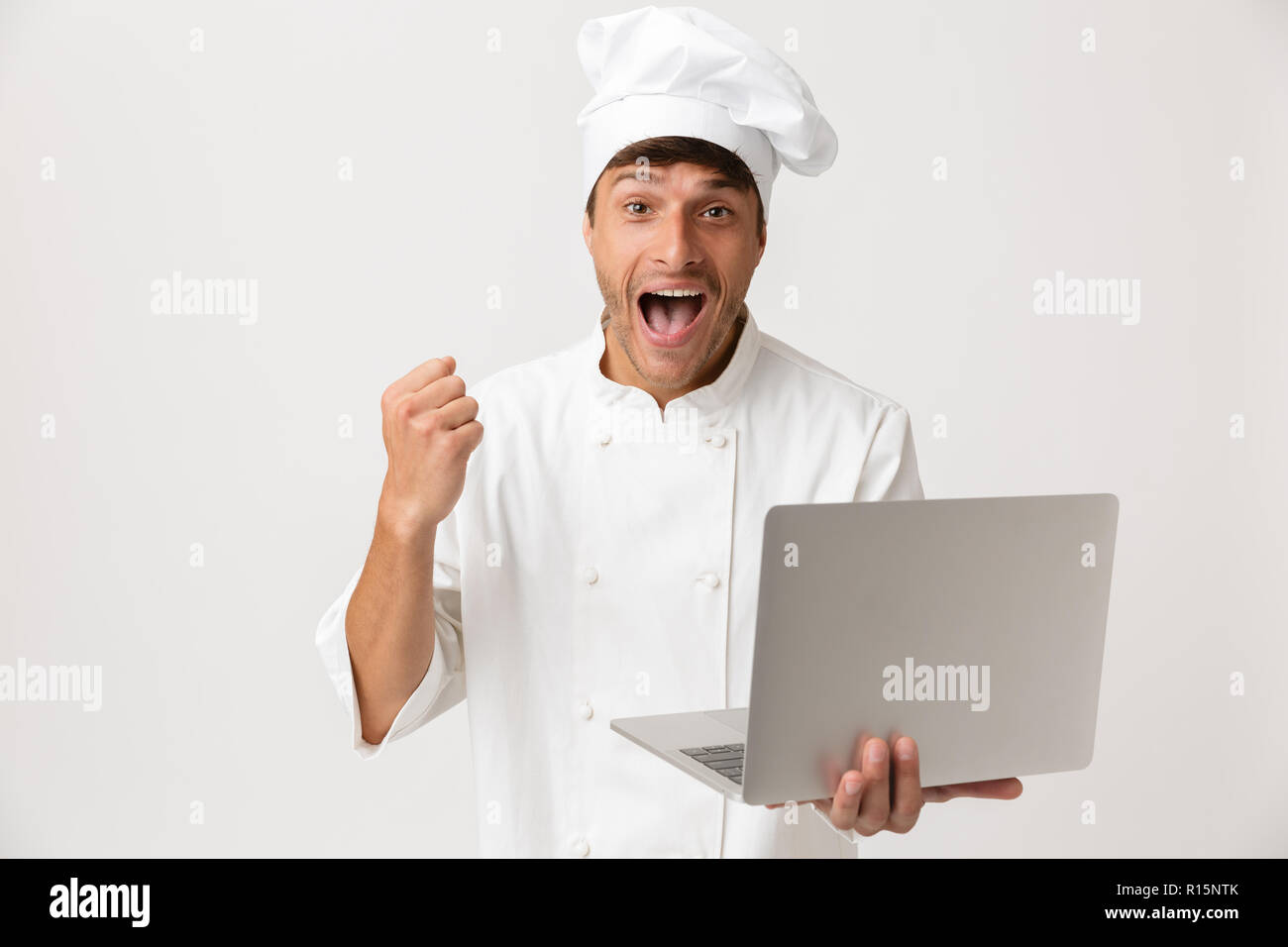 Image of excited young chef man isolated over white wall background ...