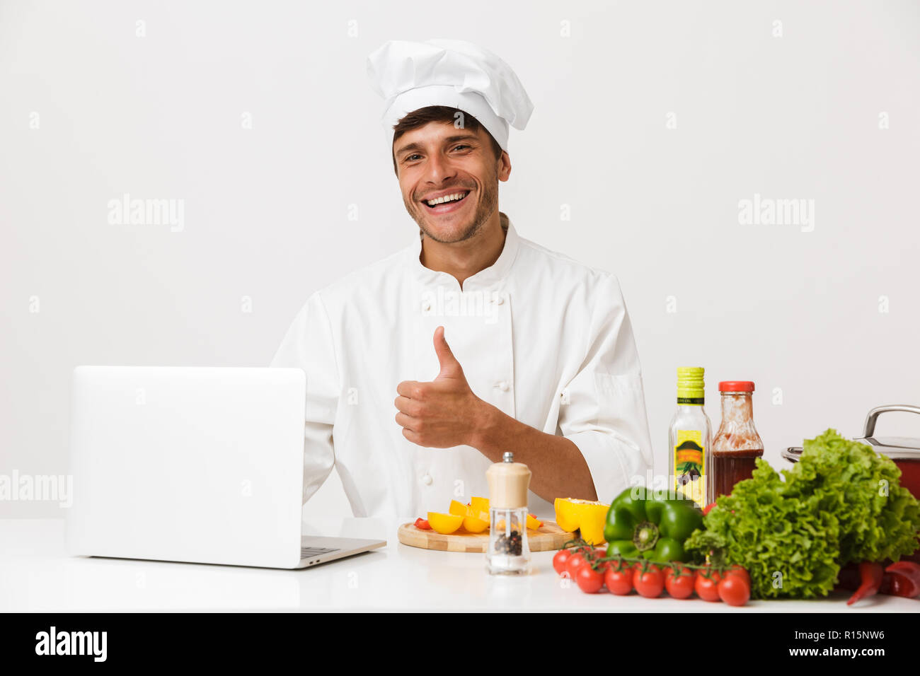 Image of handsome young chef man isolated over white wall background ...