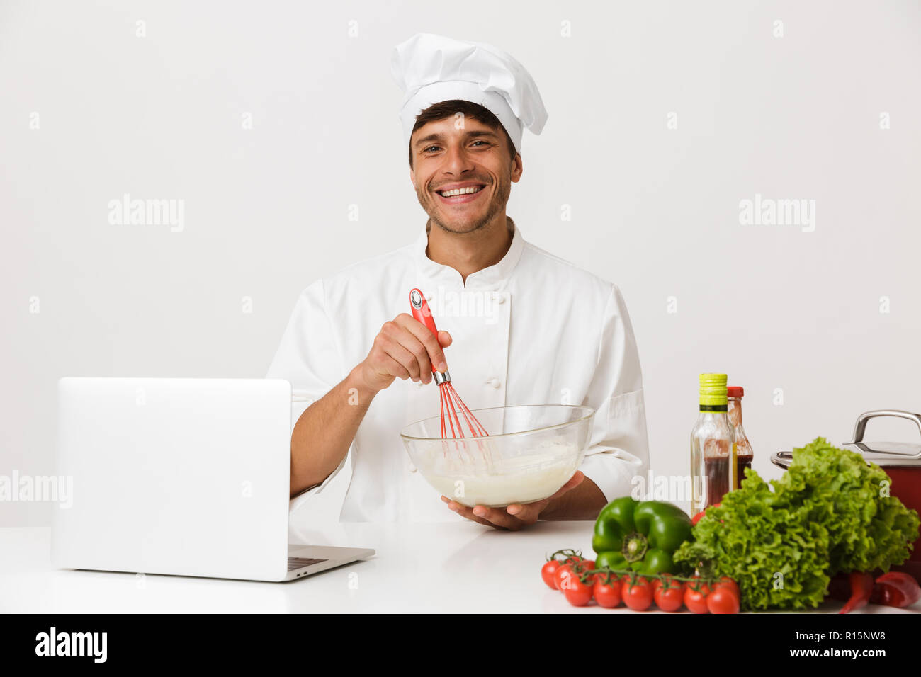 Image of handsome young chef man isolated over white wall background ...