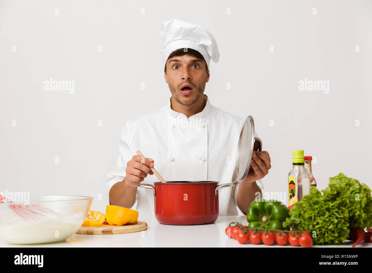 Image of handsome shocked young chef man isolated over white wall ...