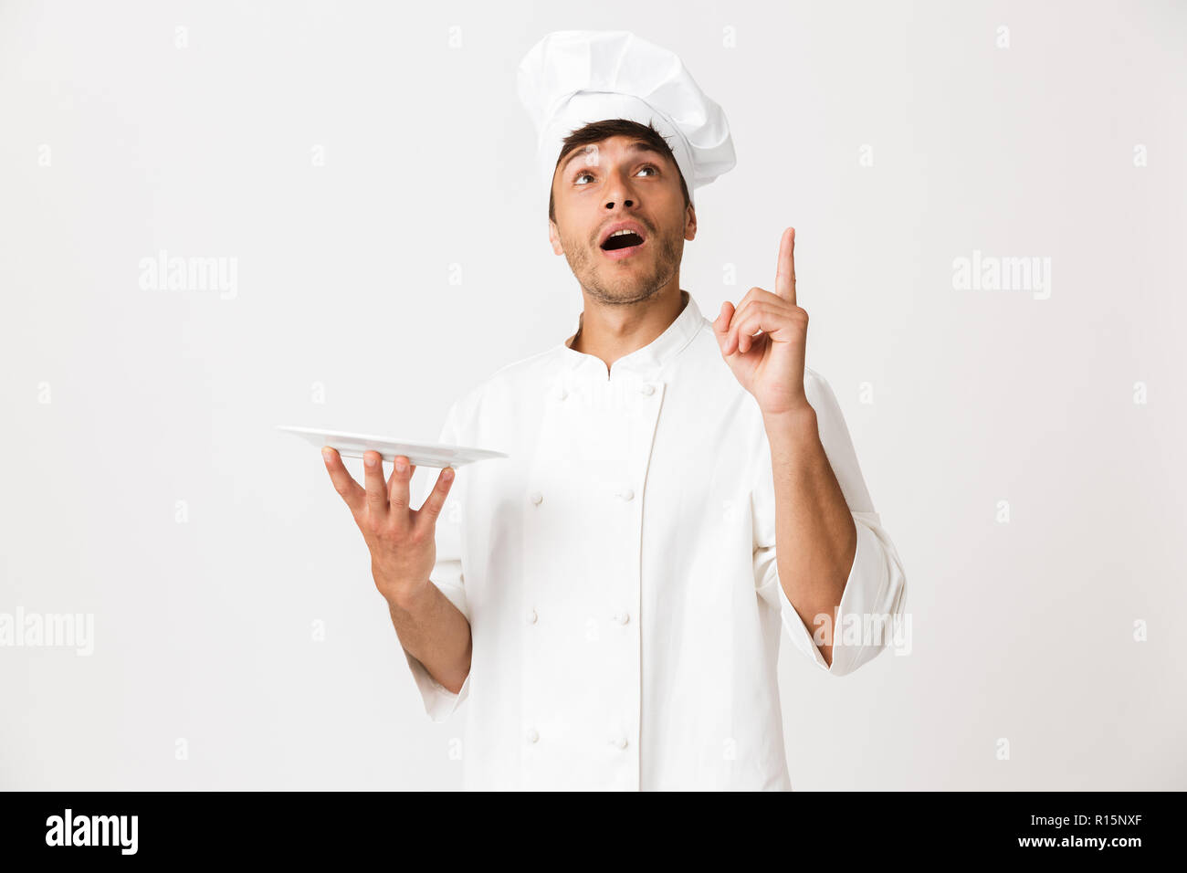 Image of shocked handsome young chef man standing isolated over white ...