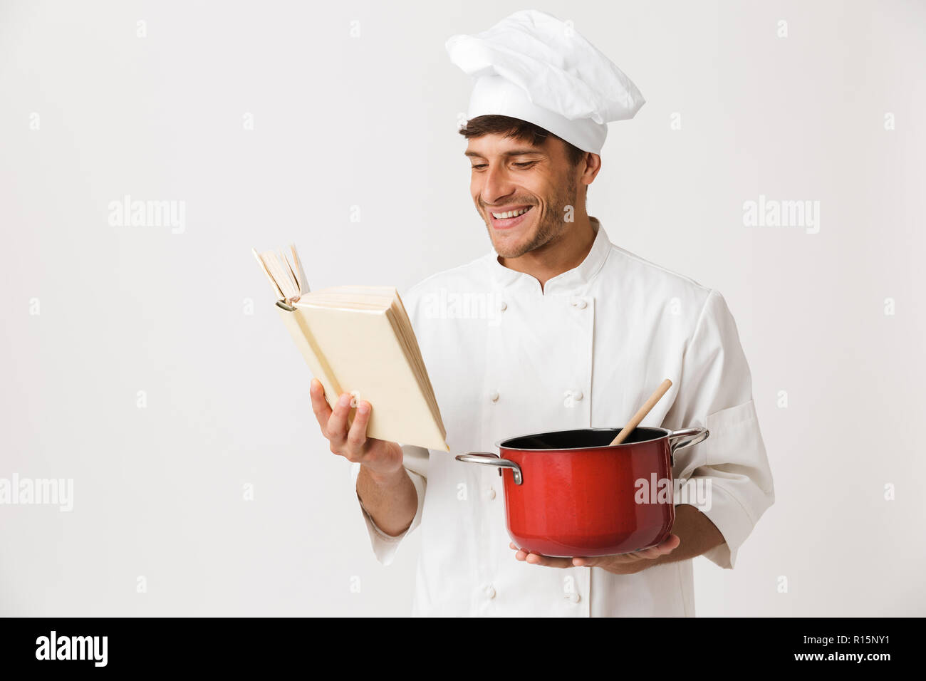 Image of handsome young chef man isolated over white wall background ...