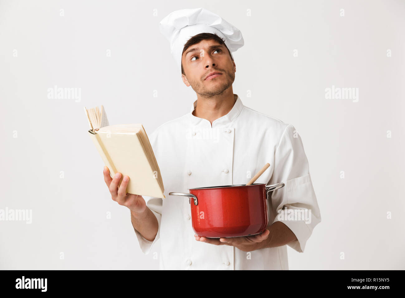 Image of thinking young chef man isolated over white wall background ...