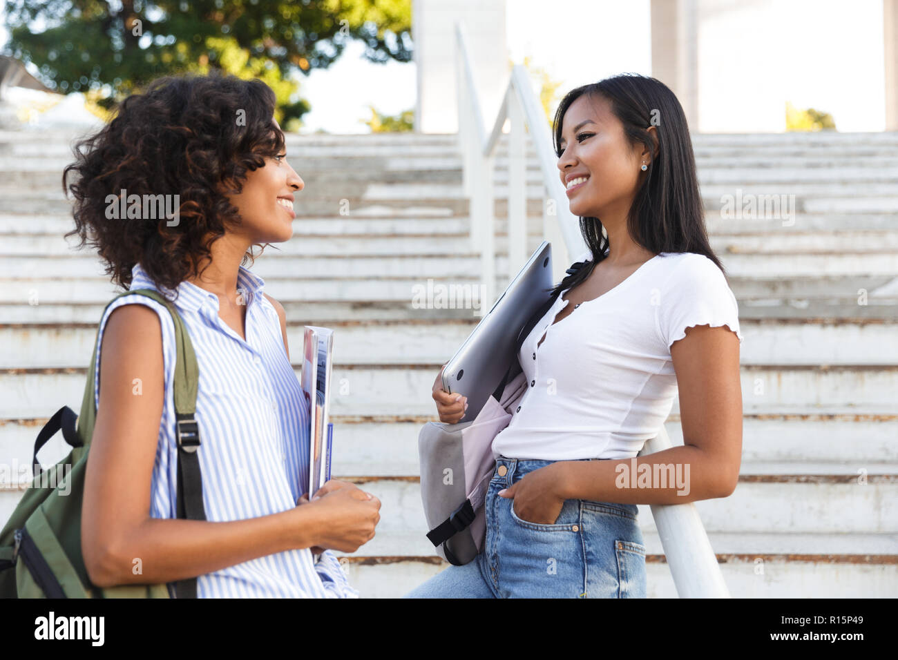 Two girls outside school talking hi-res stock photography and images ...