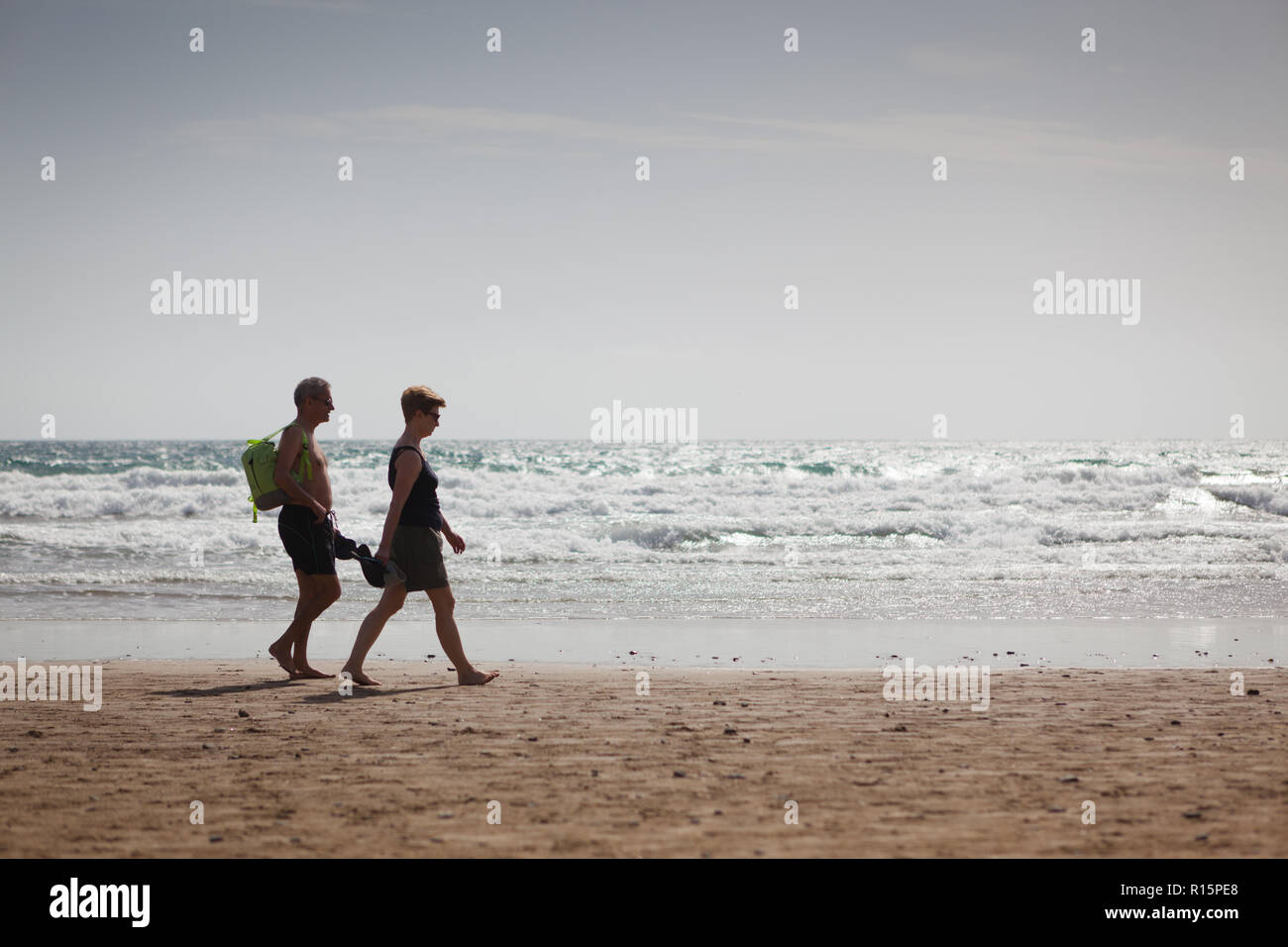 walkers on beach Stock Photo - Alamy