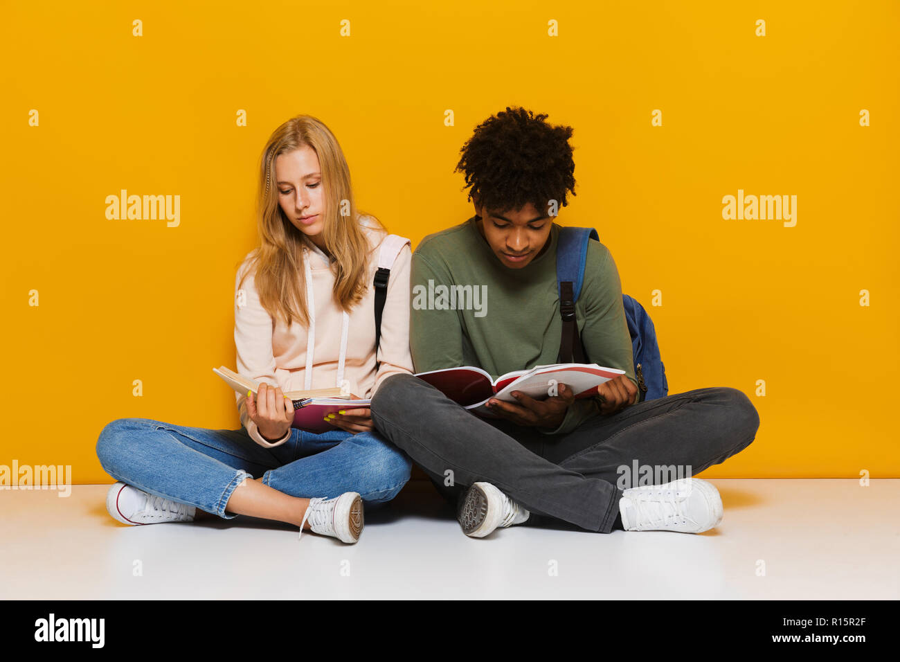 Photo of bored or upset students 16-18 using reading books while ...