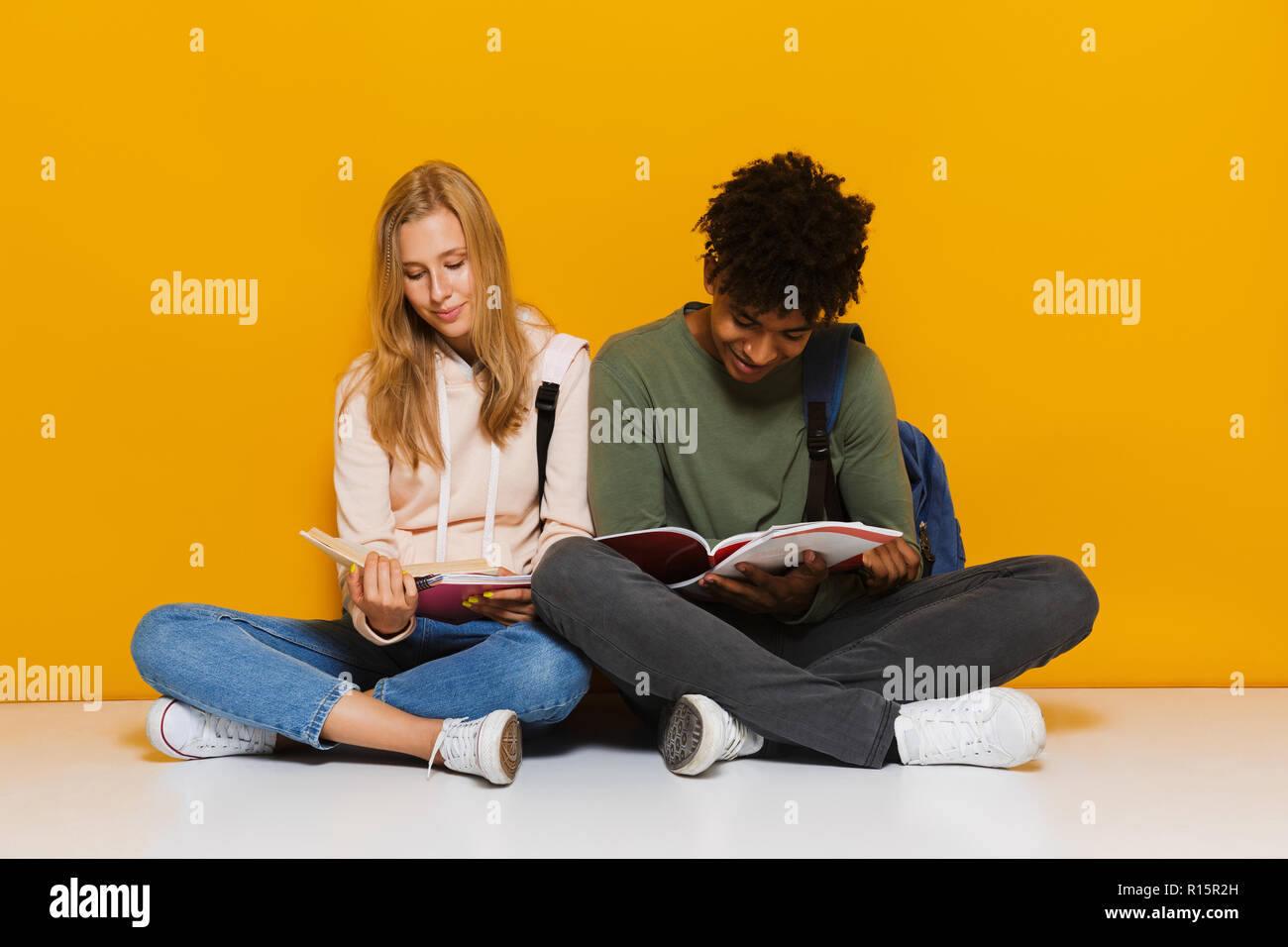 Photo of smart students 16-18 using reading books while sitting on ...