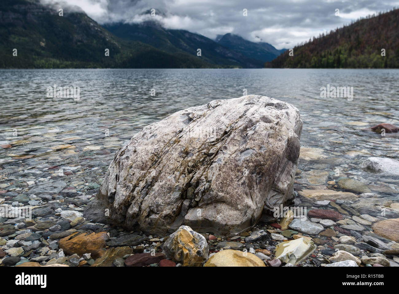 Unique rock on a peaceful lake in the Canadian wilderness Stock Photo ...