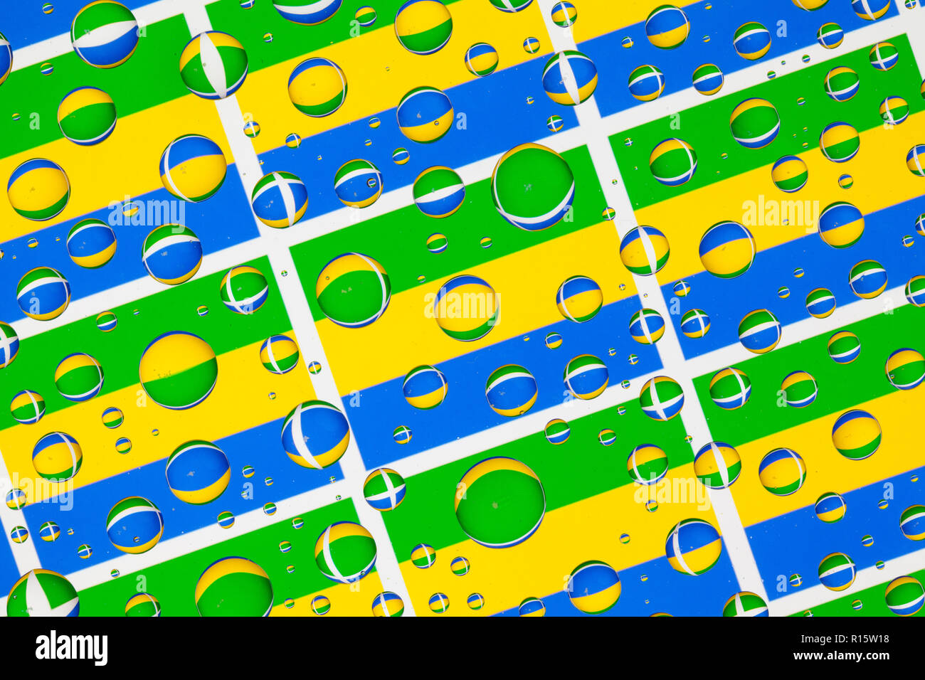 Flags of Gabon, behind a glass covered with rain drops.Pattern from ...