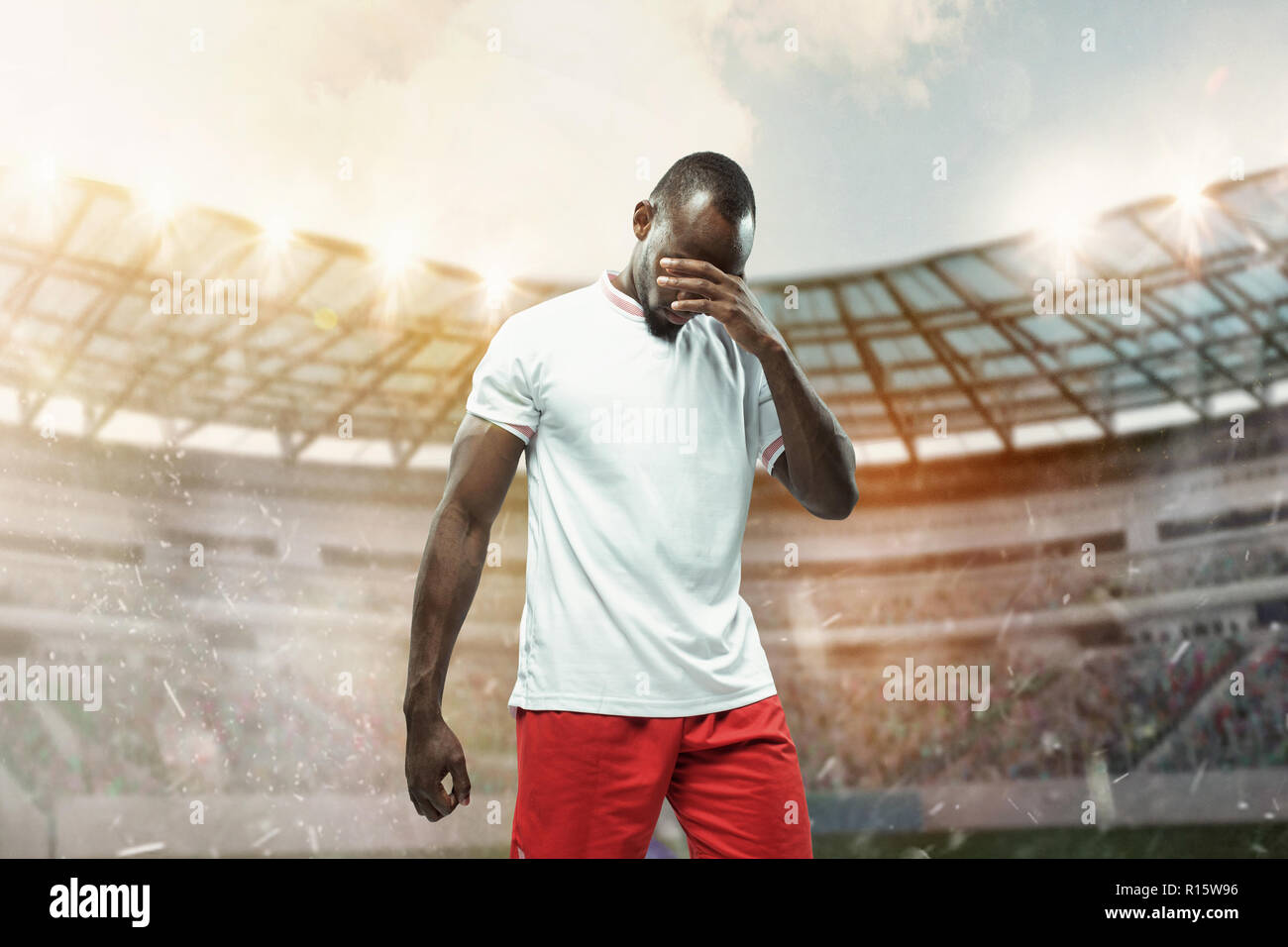 The football african player in motion on the field of stadium at day ...